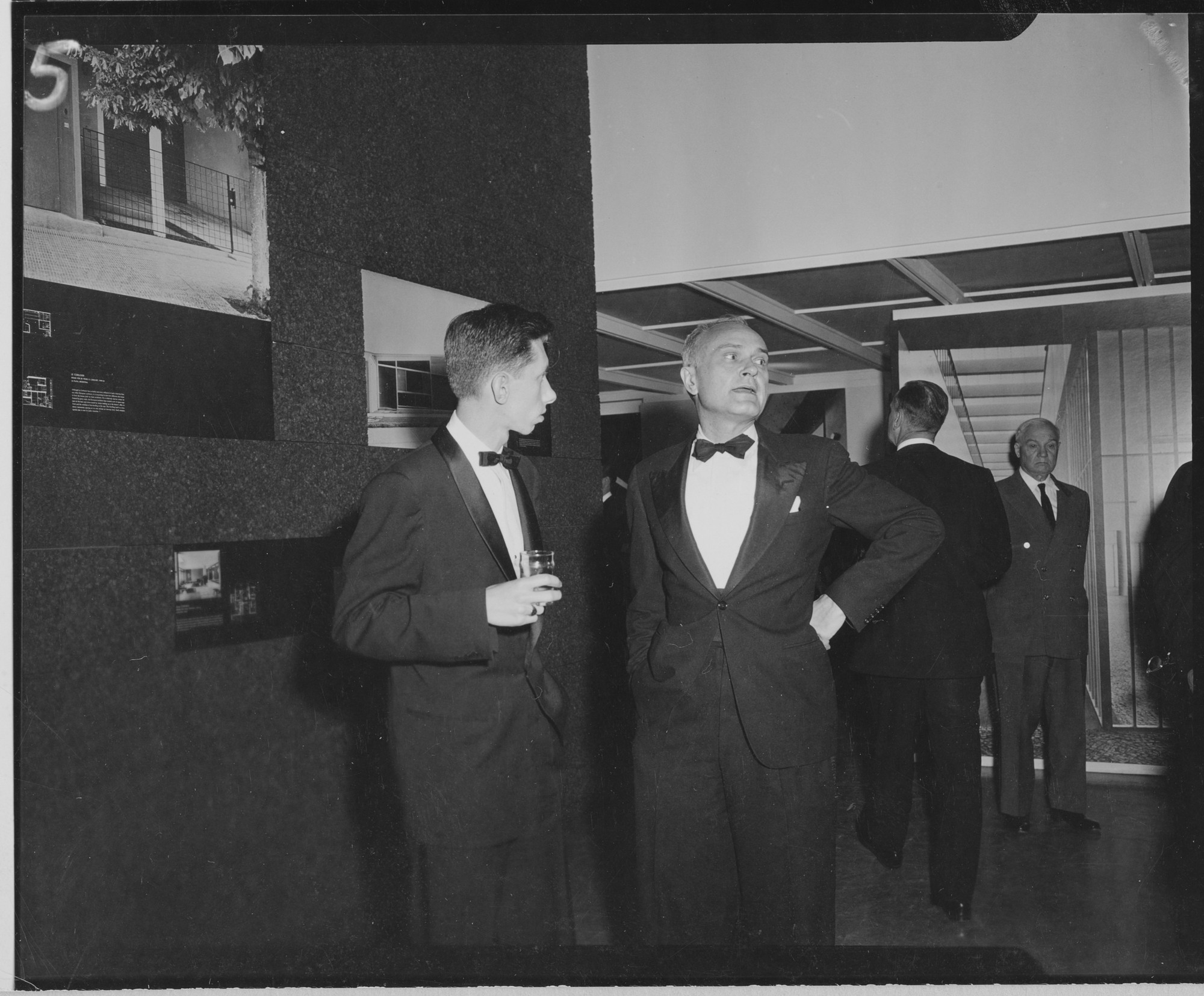 Left, Arthur Drexler with unidentified guest at the opening of the ...