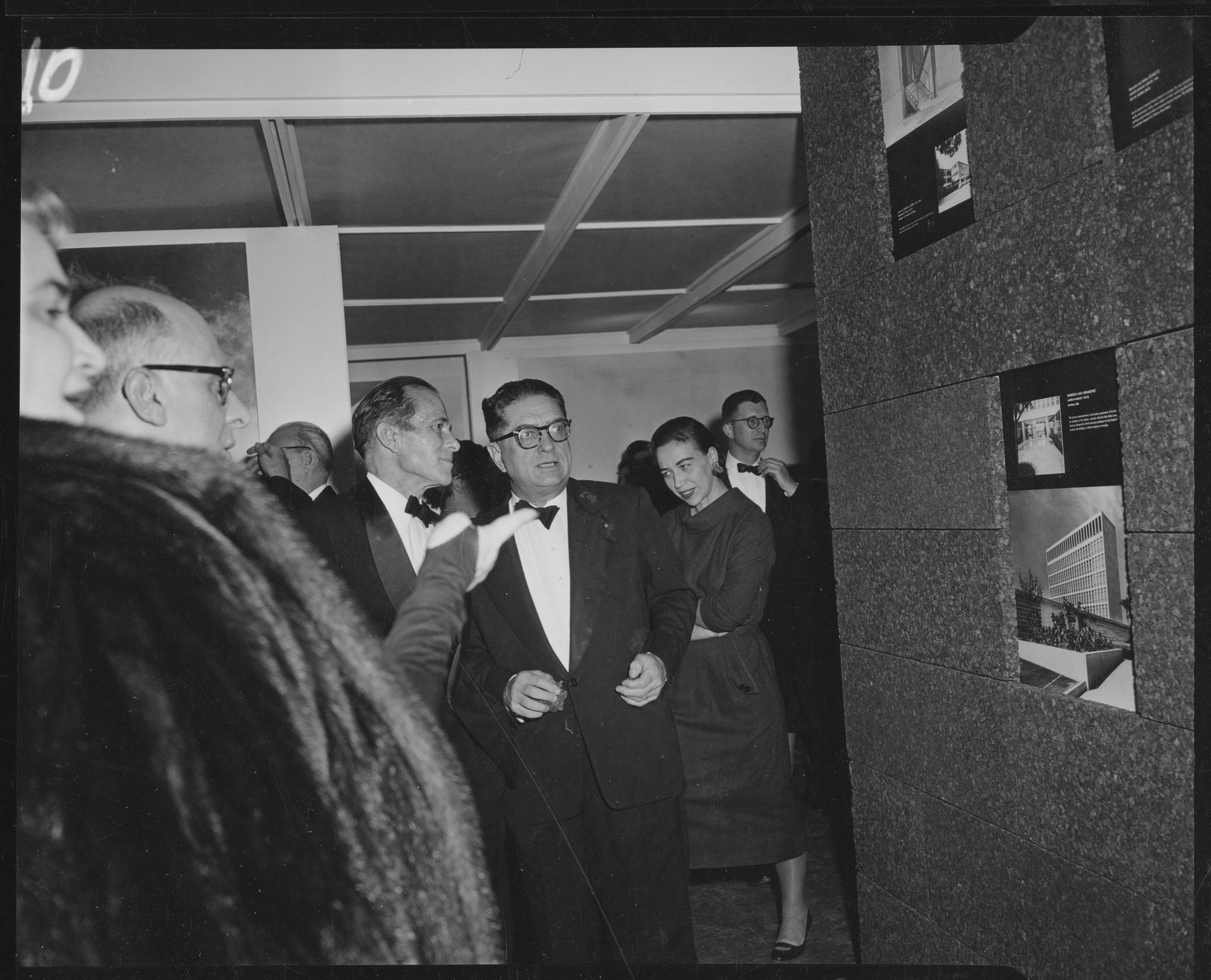 Unidentified guests and (second from right) Monroe Wheeler at the ...