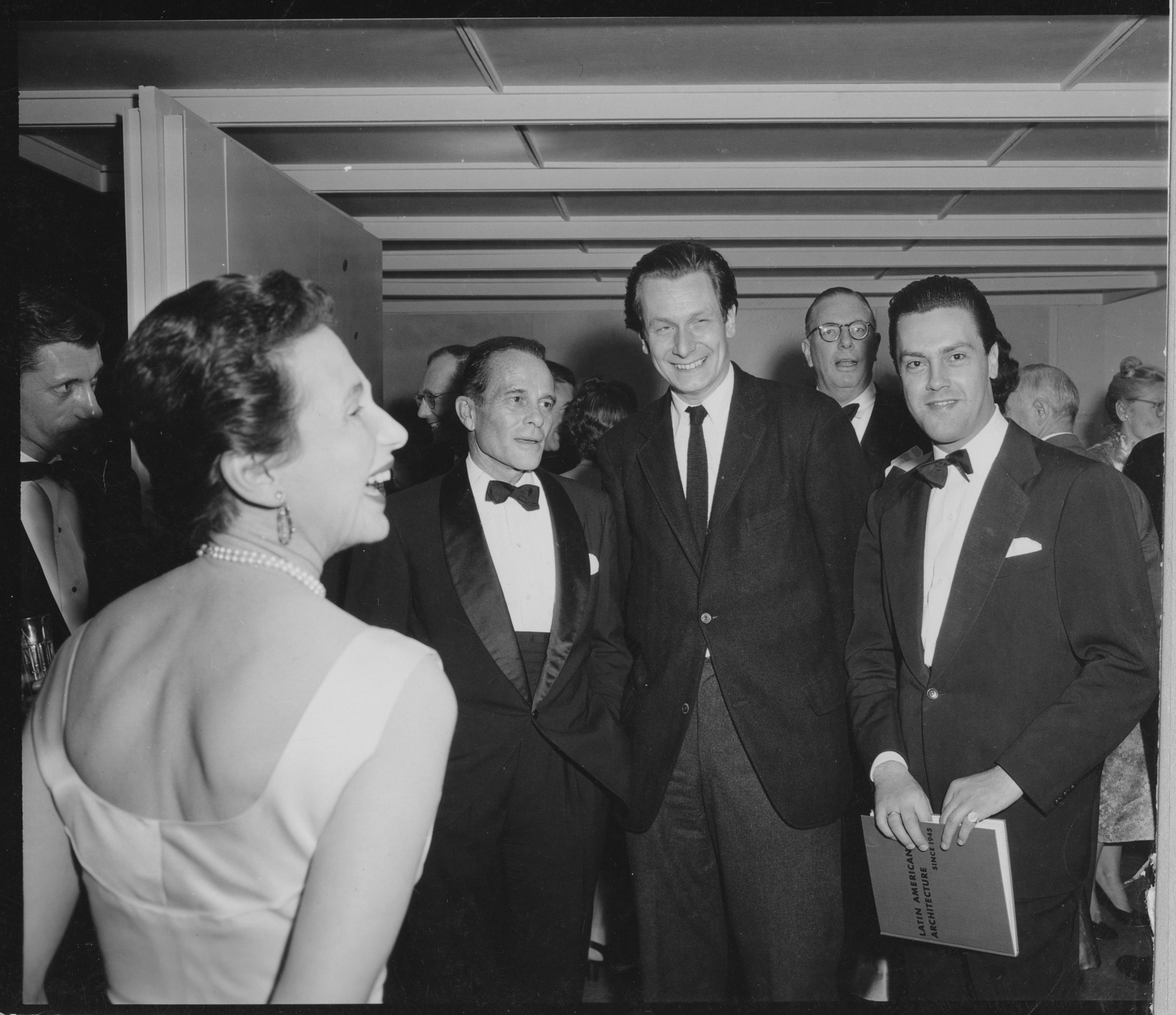 Monroe Wheeler (first on left in the group of three men) and ...