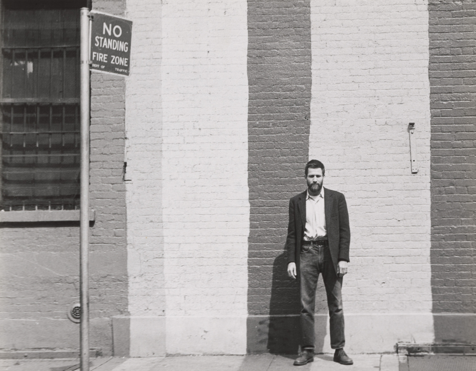 Fred W. McDarrah. Allan Kaprow portrait in front of painted brick wall ...